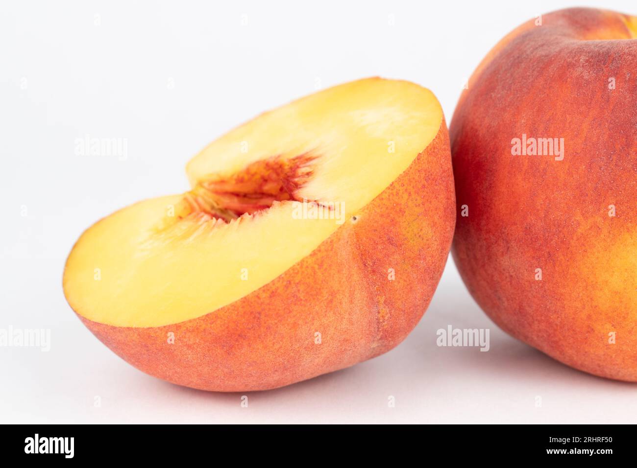 Sliced half peach no pit white background Stock Photo - Alamy