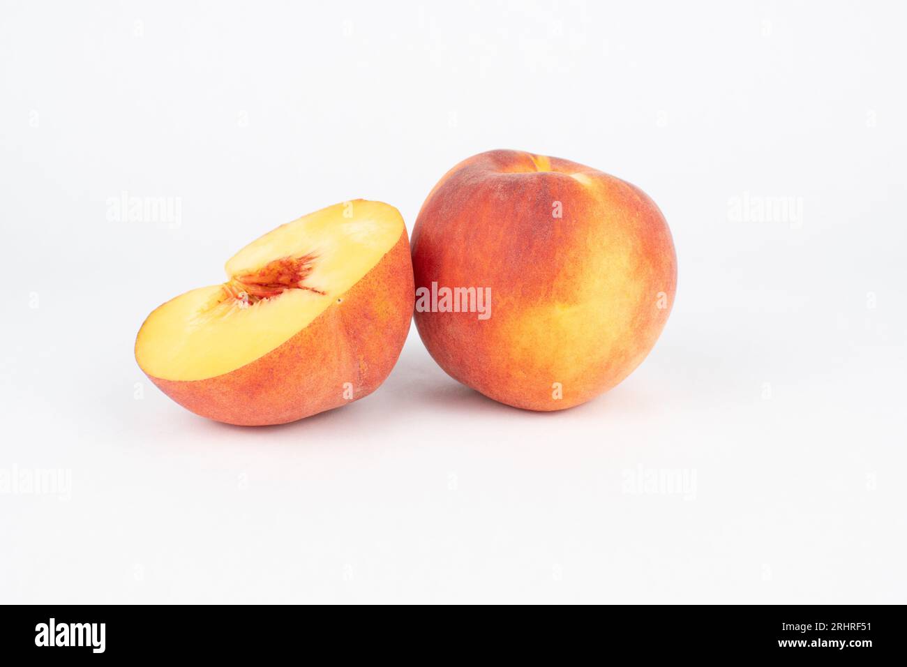 Sliced half peach no pit white background Stock Photo - Alamy