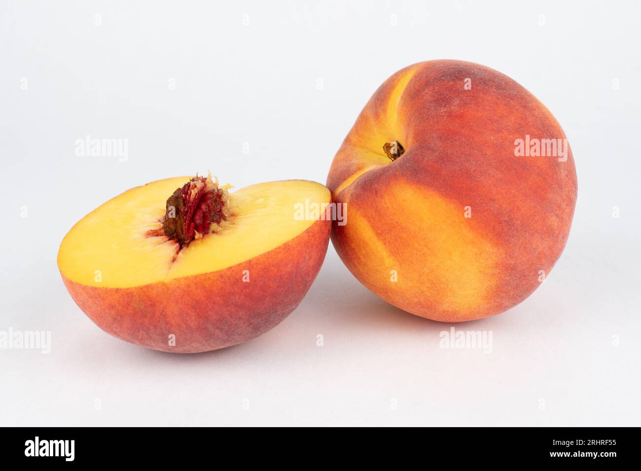 Sliced half peach with pit white background Stock Photo - Alamy