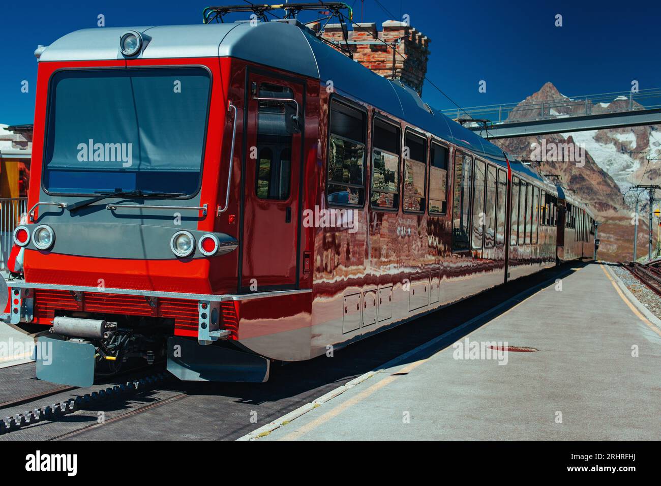 Alps high mountain train station with red train Stock Photo - Alamy