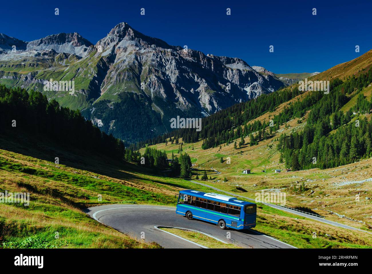 Passenger bus riding at Swiss Alps mountains in summer Stock Photo - Alamy
