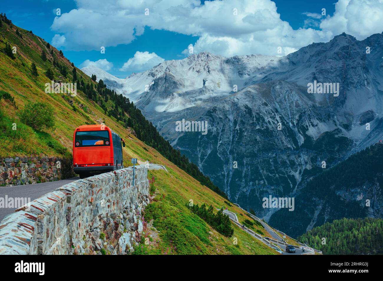Red touristic bus riding at Swiss Alps mountains in summer Stock Photo ...
