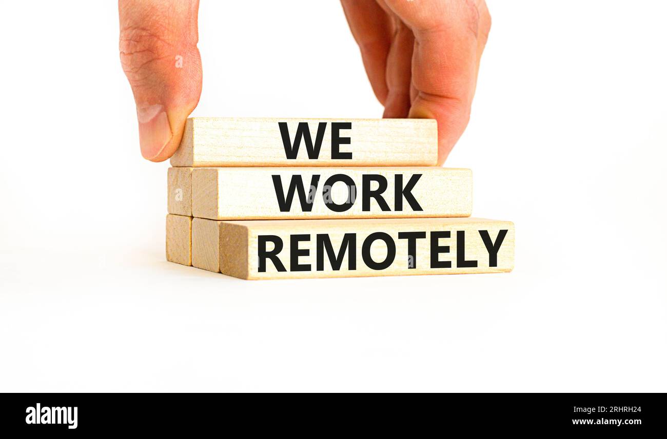 We work remotely symbol. Concept words We work remotely on wooden block ...