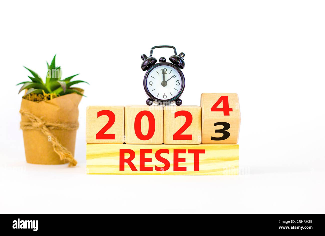 2024 reset new year symbol. Businessman turns a wooden cube and changes words Reset 2023 to ...