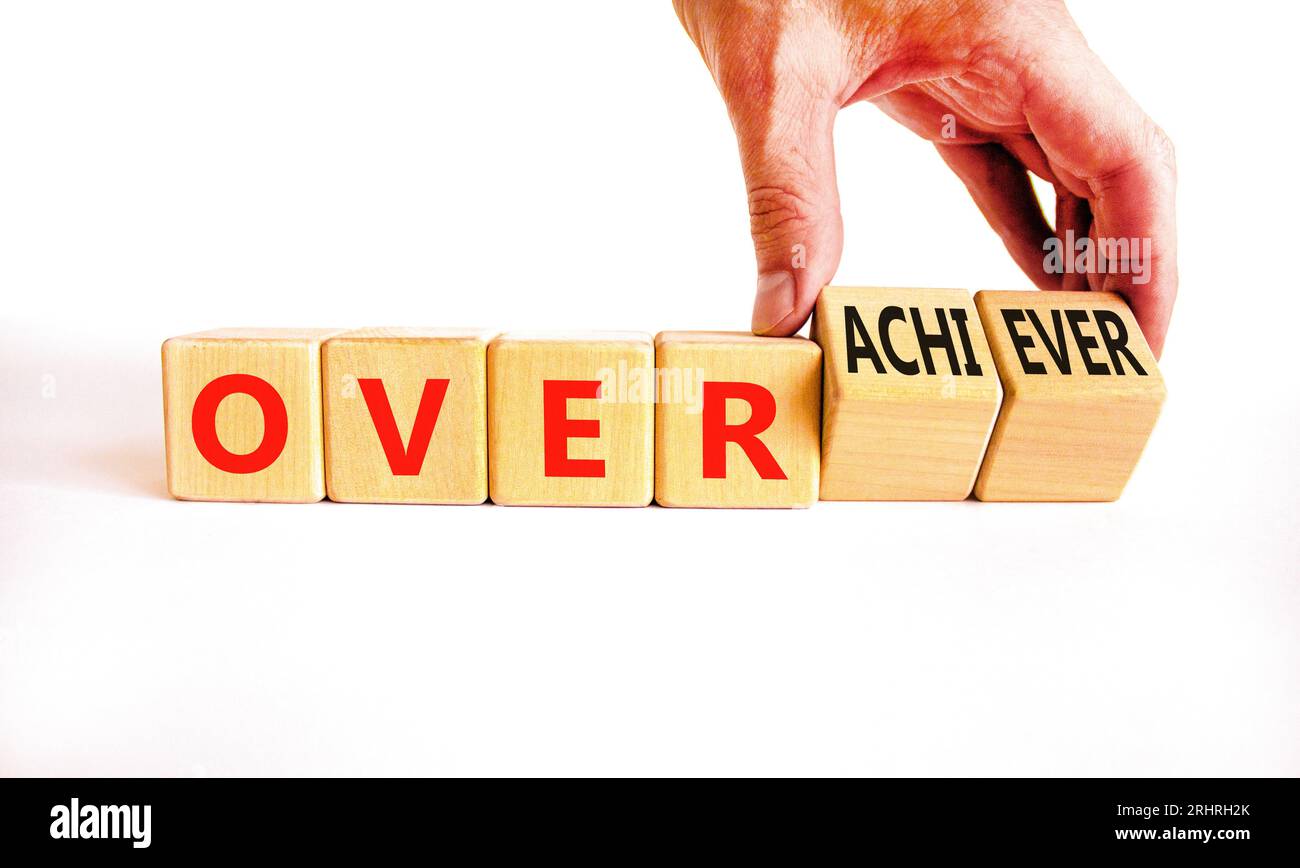 Achiever or overachiever symbol. Businessman turns wooden cubes and ...