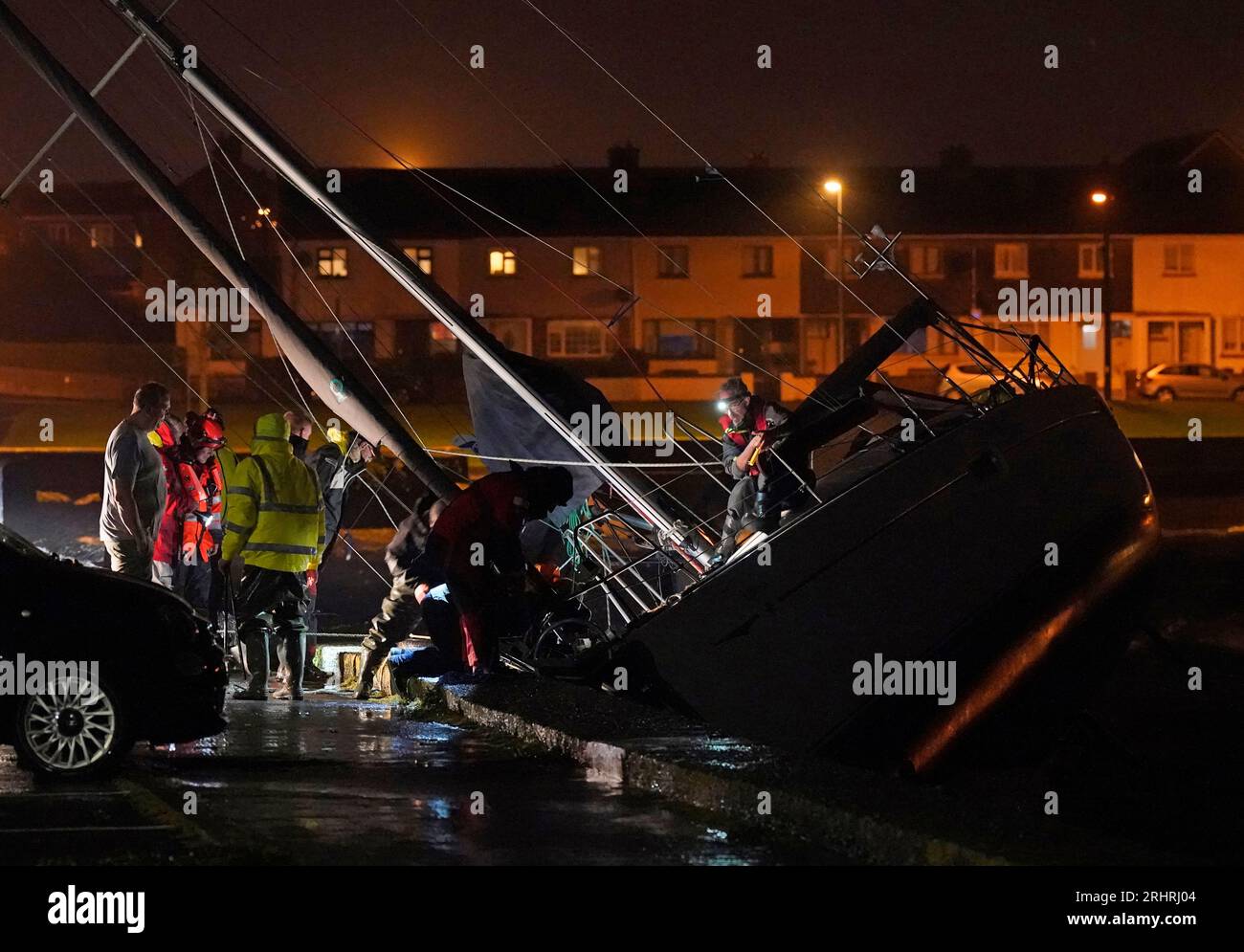 Members of the Coast Guard inspect the damage to a boat after it broke ...