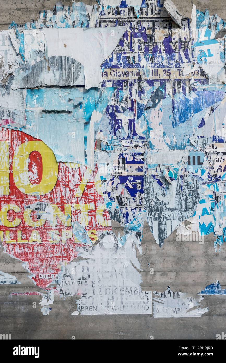 Concrete wall with colorful ripped bill posters. Grunge background ...