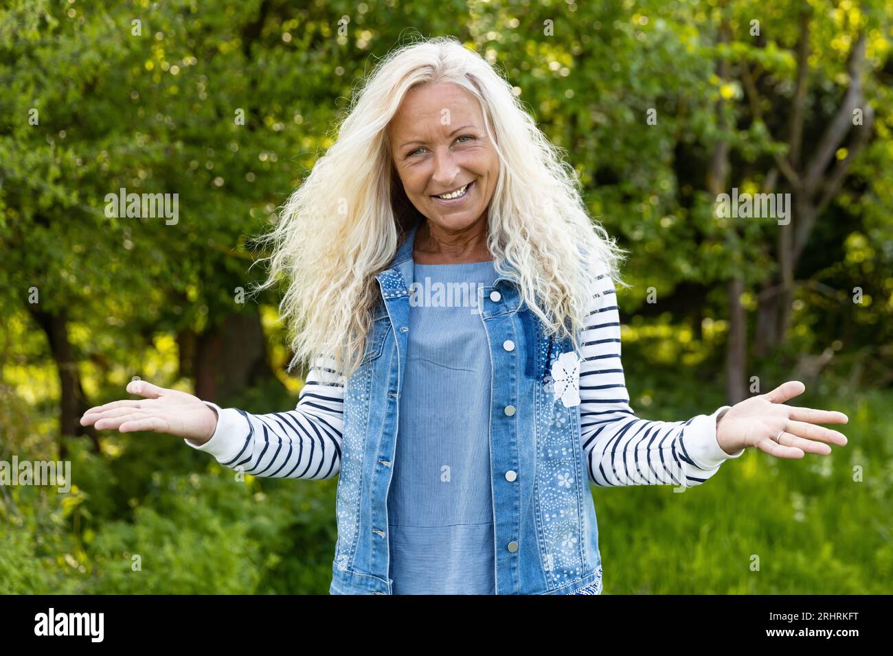 Happy caucasian woman with long hair raise her arms Stock Photo - Alamy