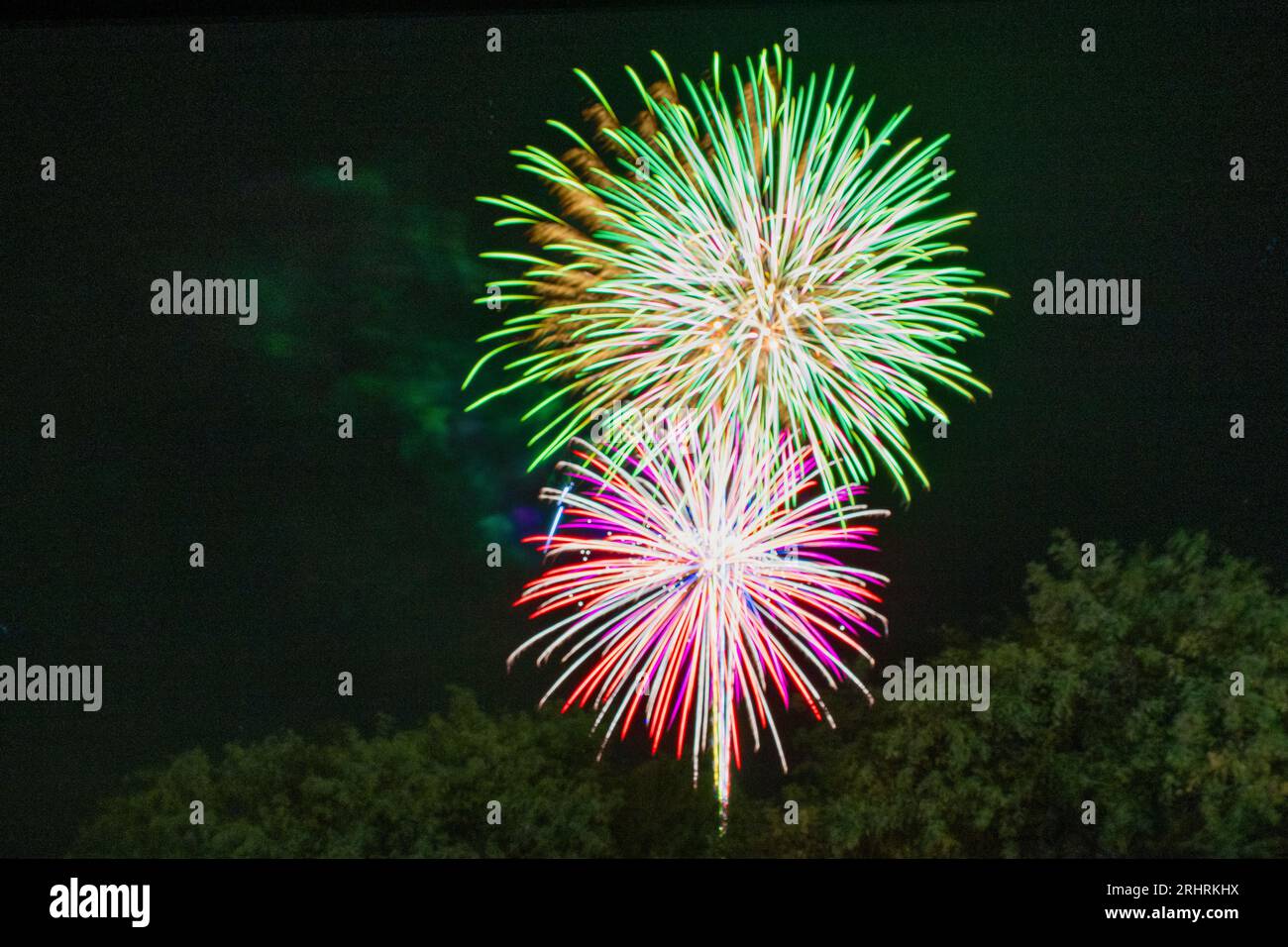 A burst of coloured light trails light up the night as fireworks expode ...