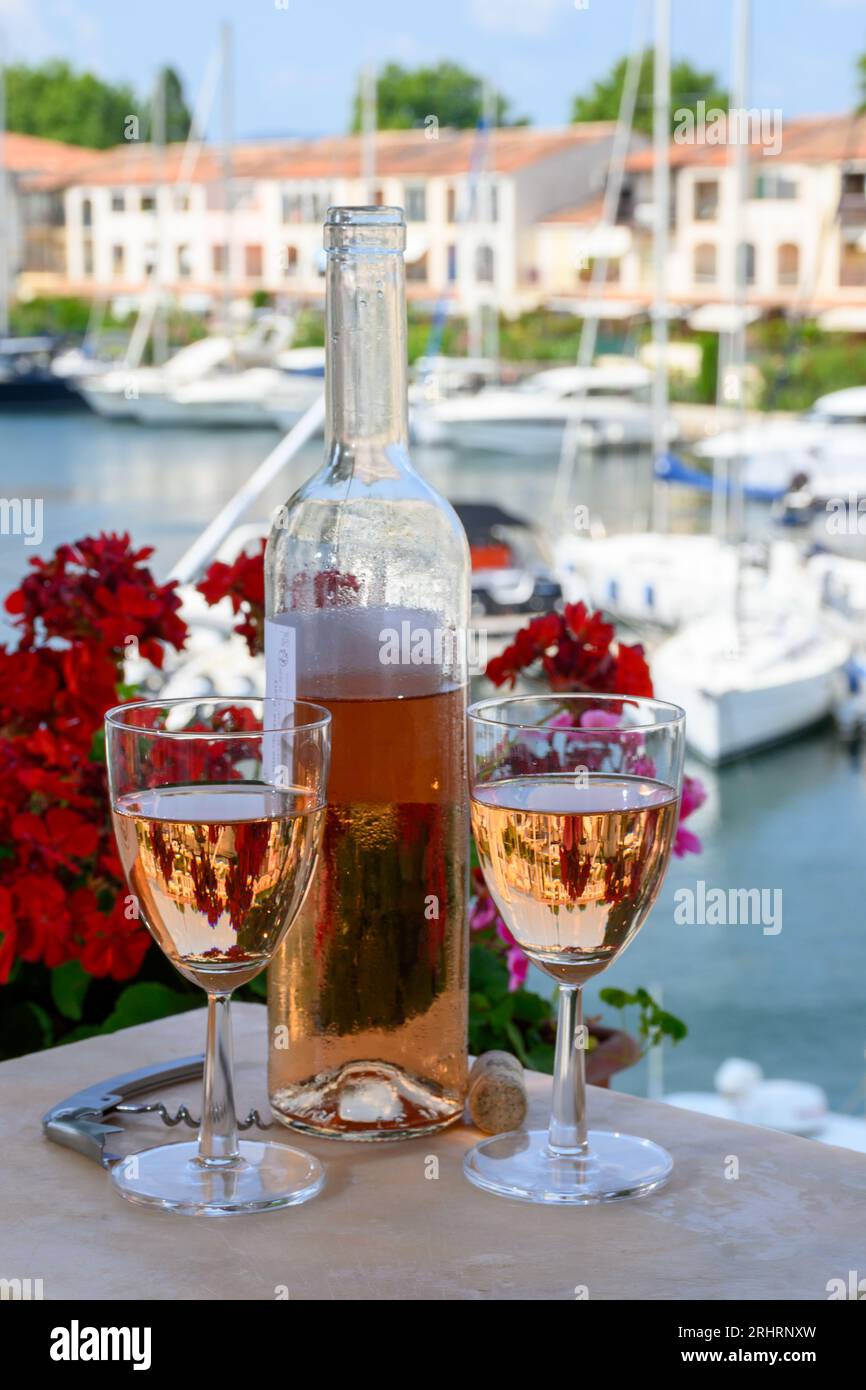 Glasses of cold rose Cote de Provence wine in yacht harbour of Port ...