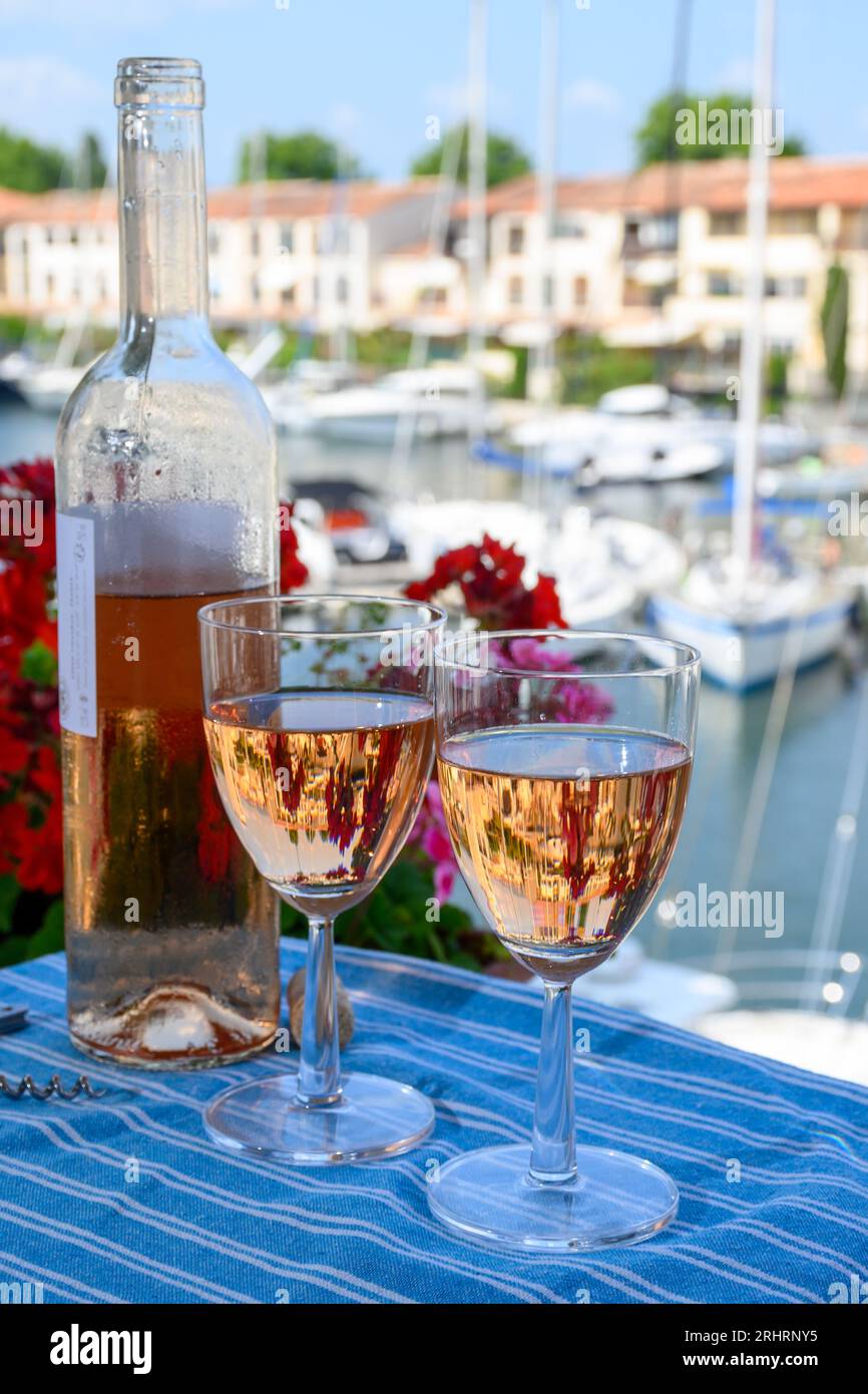 Glasses of cold rose Cote de Provence wine in yacht harbour of Port ...