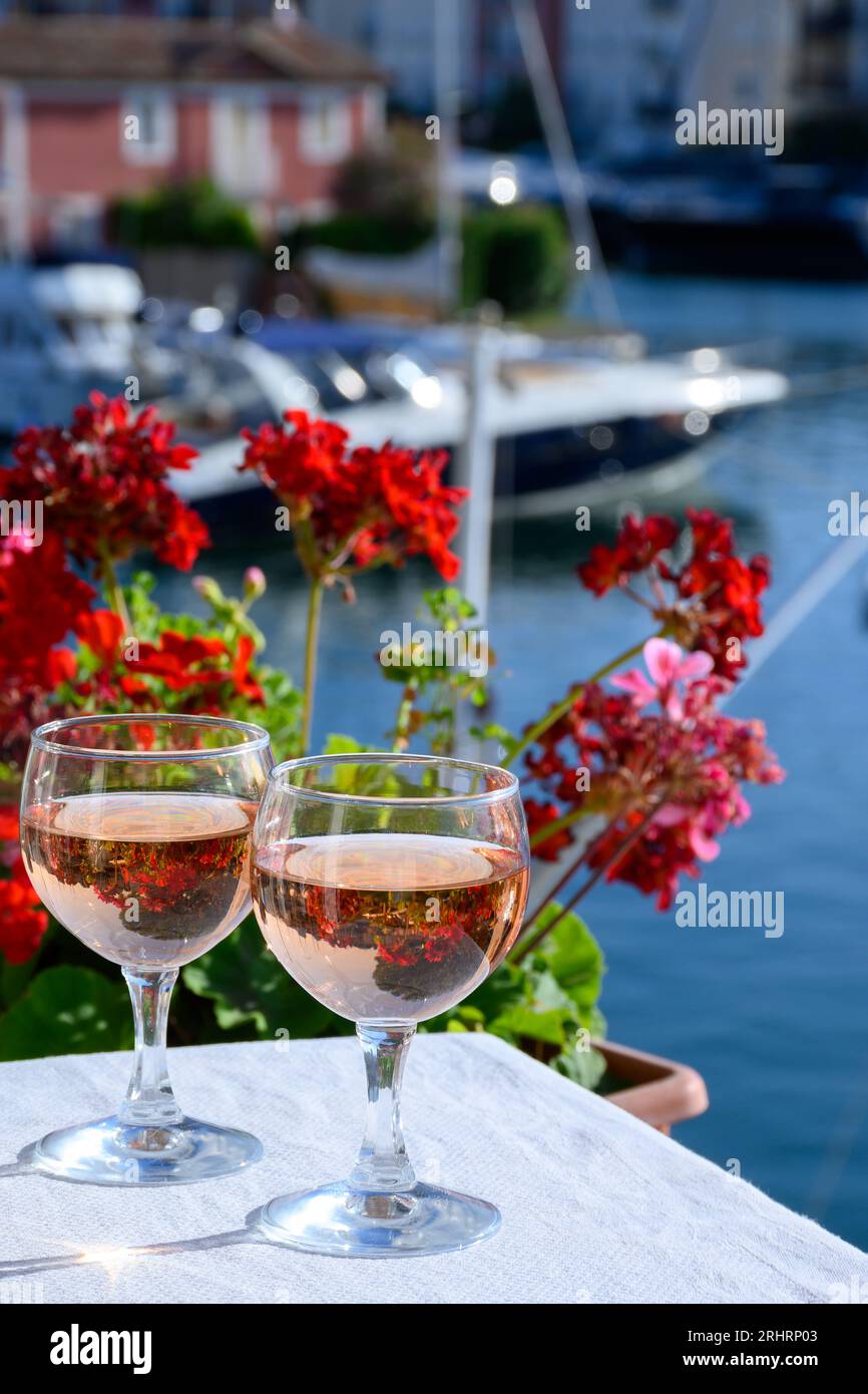 Glasses of cold rose Cote de Provence wine in yacht harbour of Port ...