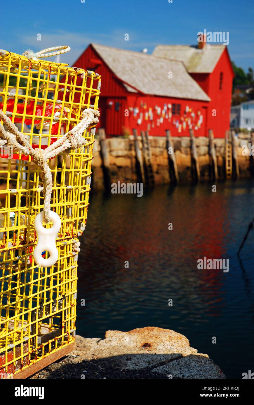 Lobster traps are piled on the docks at the harbor of Rockport, on Cape ...