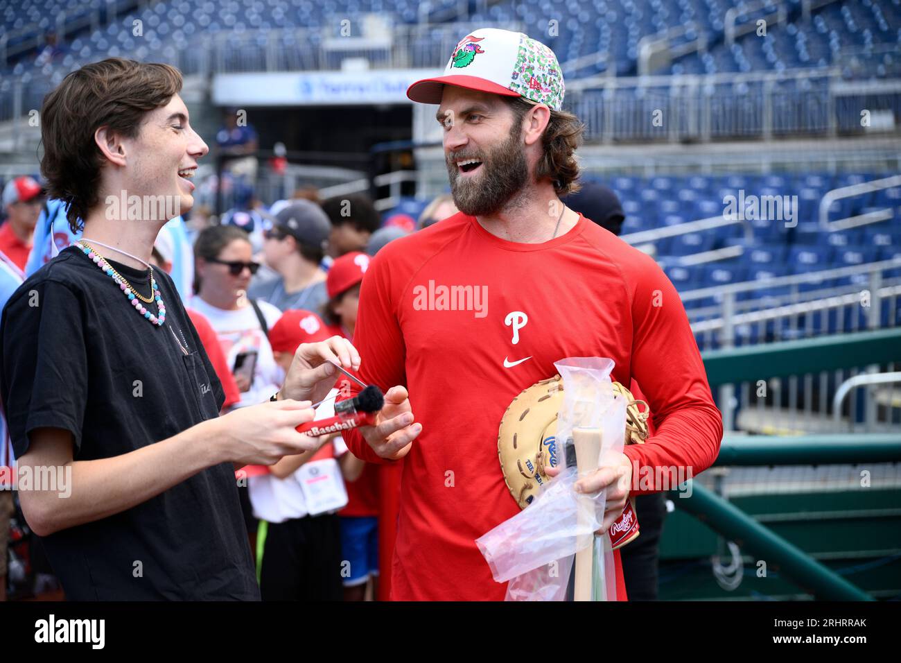Philadelphia Phillies' Bryce Harper, right, gets interviewed before a ...