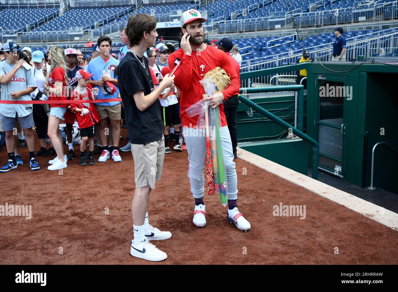 Philadelphia Phillies' Bryce Harper, right, gets interviewed before a ...