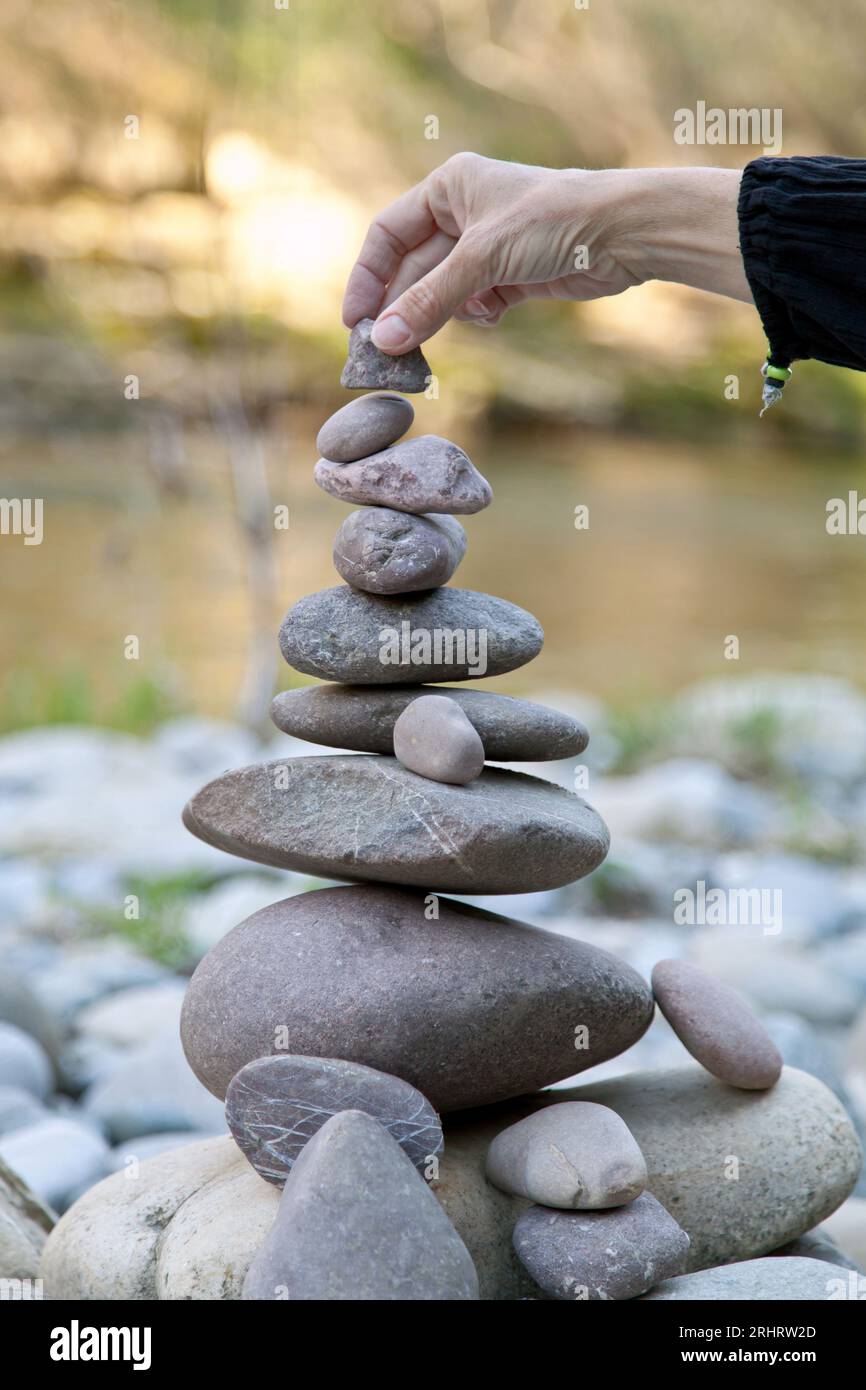 Hand stacking stones hi-res stock photography and images - Alamy
