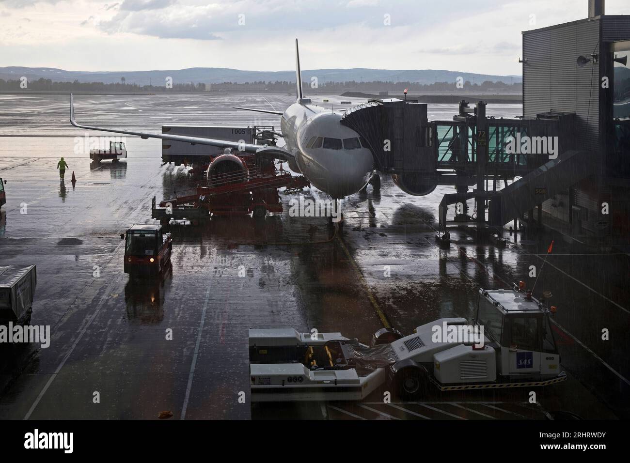 difficult conditions due to heavy rain at the airport when loading an ...