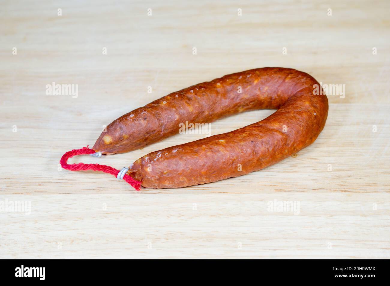 Spanish Chorizo Ring on Wooden Chopping Board Stock Photo - Alamy