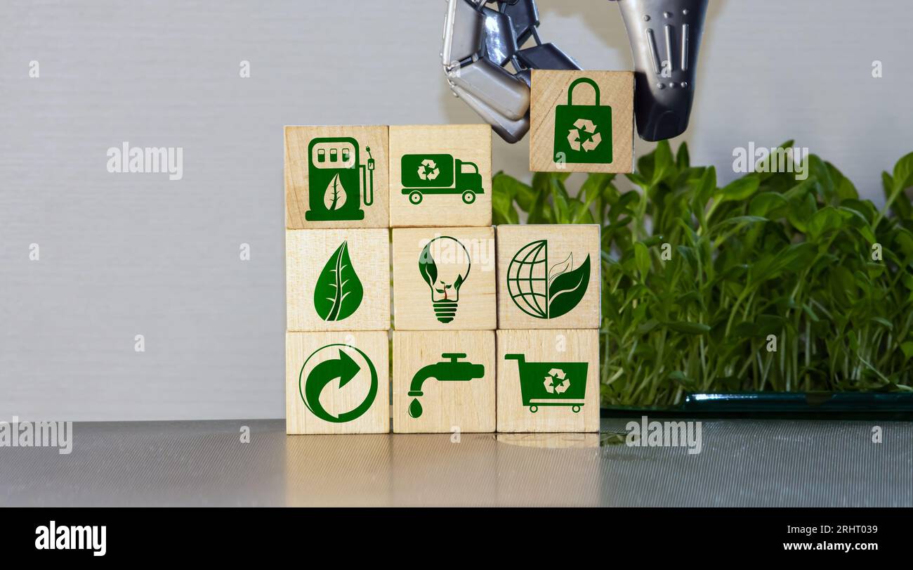Crop person arranging small wooden blocks together to compose recycle ...