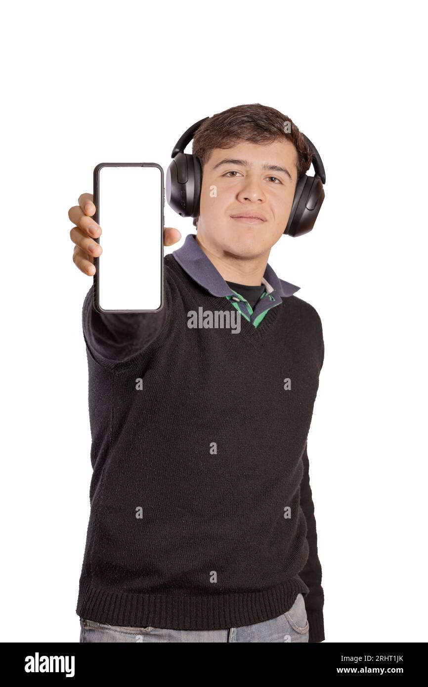 Caucasian boy with headphones shows the blank screen of his mobile ...