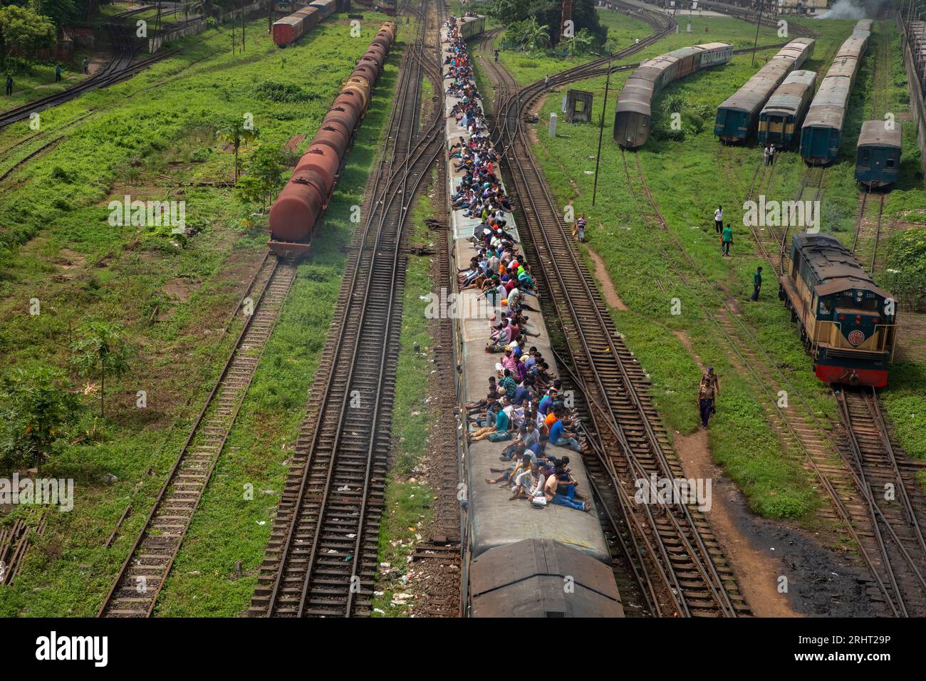 An overcrowded train leaves the Kamlapur Railway Station in Dhaka ahead ...