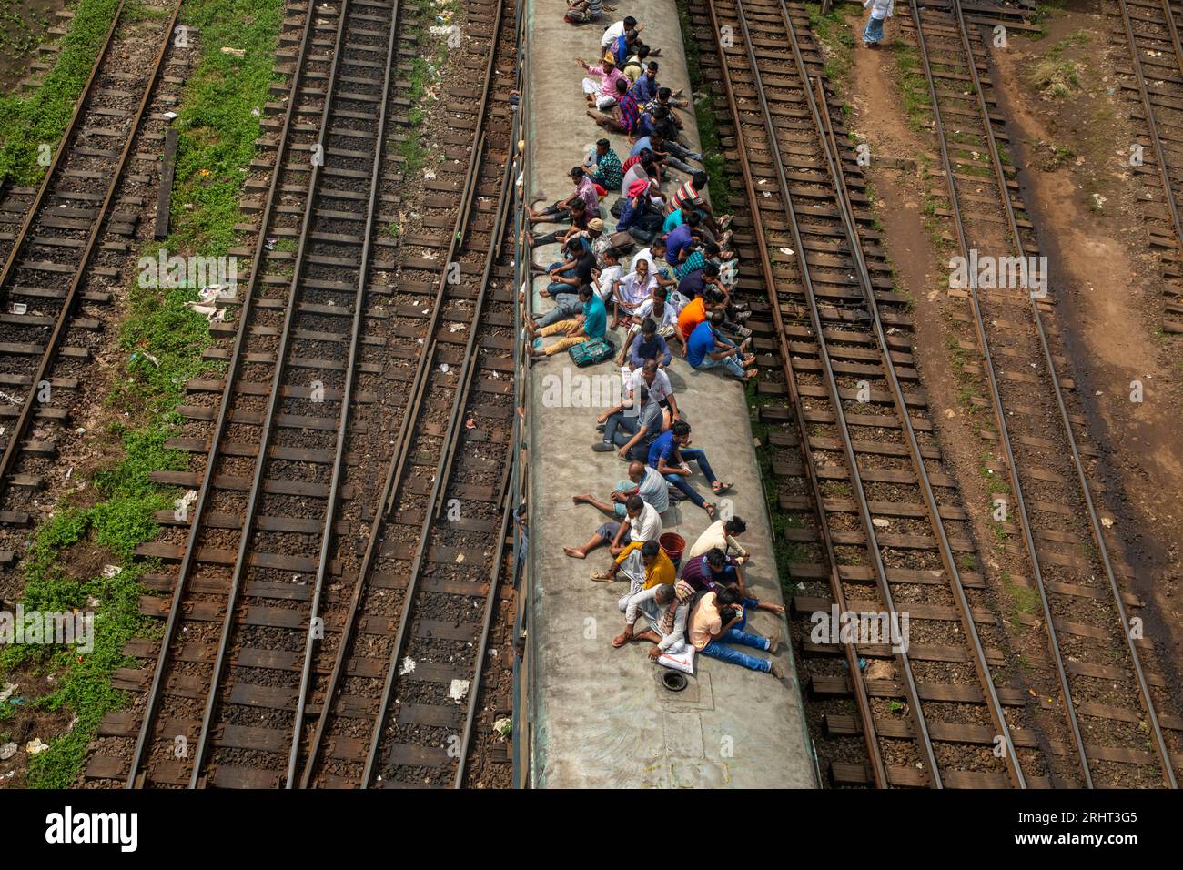 An overcrowded train leaves the Kamlapur Railway Station in Dhaka ahead ...