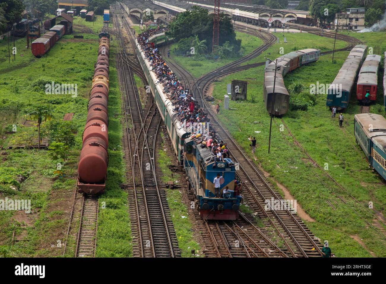 An overcrowded train leaves the Kamlapur Railway Station in Dhaka ahead ...
