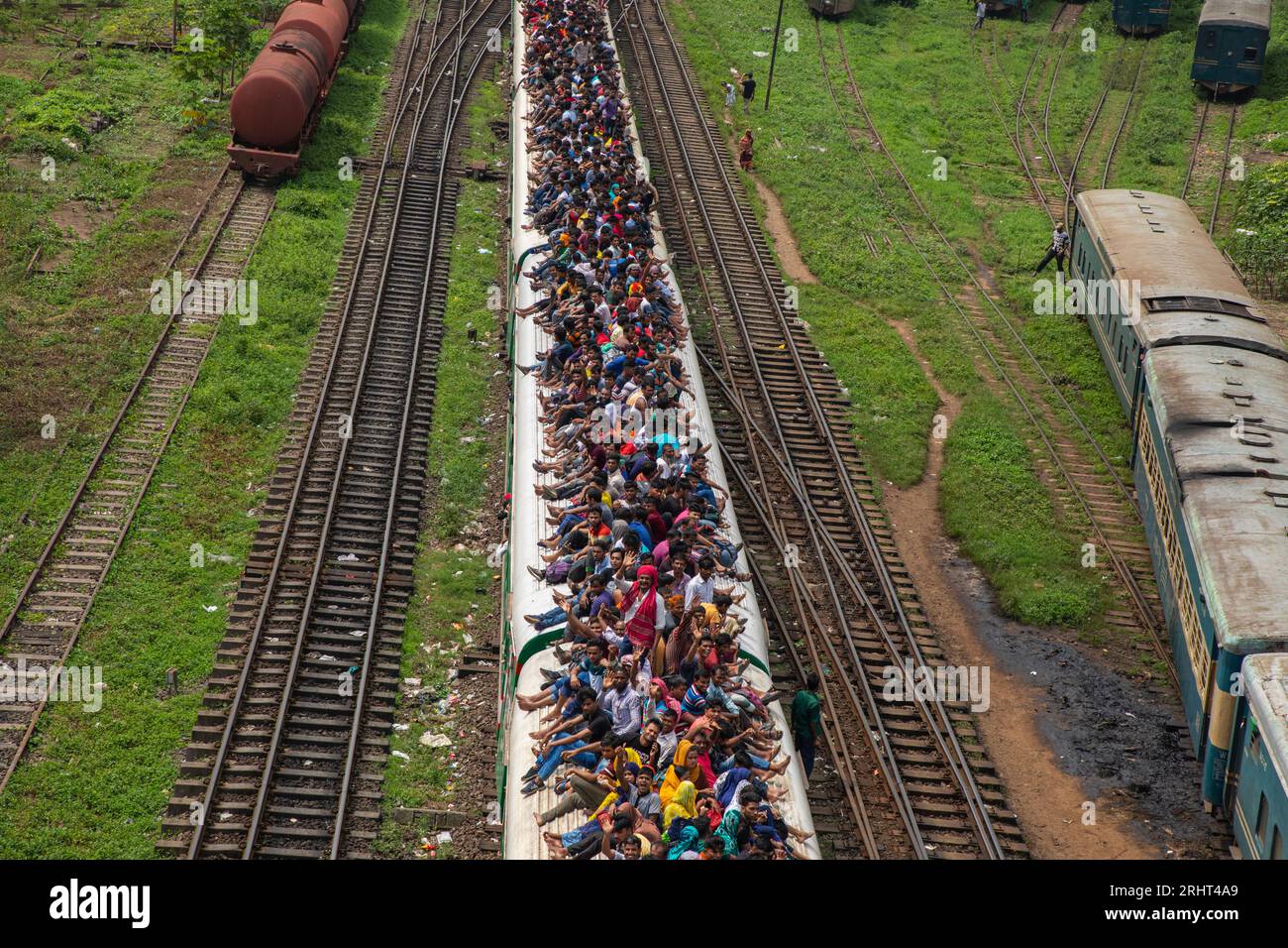 An overcrowded train leaves the Kamlapur Railway Station in Dhaka ahead ...
