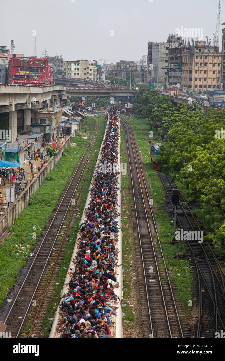 An overcrowded train leaves the Kamlapur Railway Station in Dhaka ahead ...