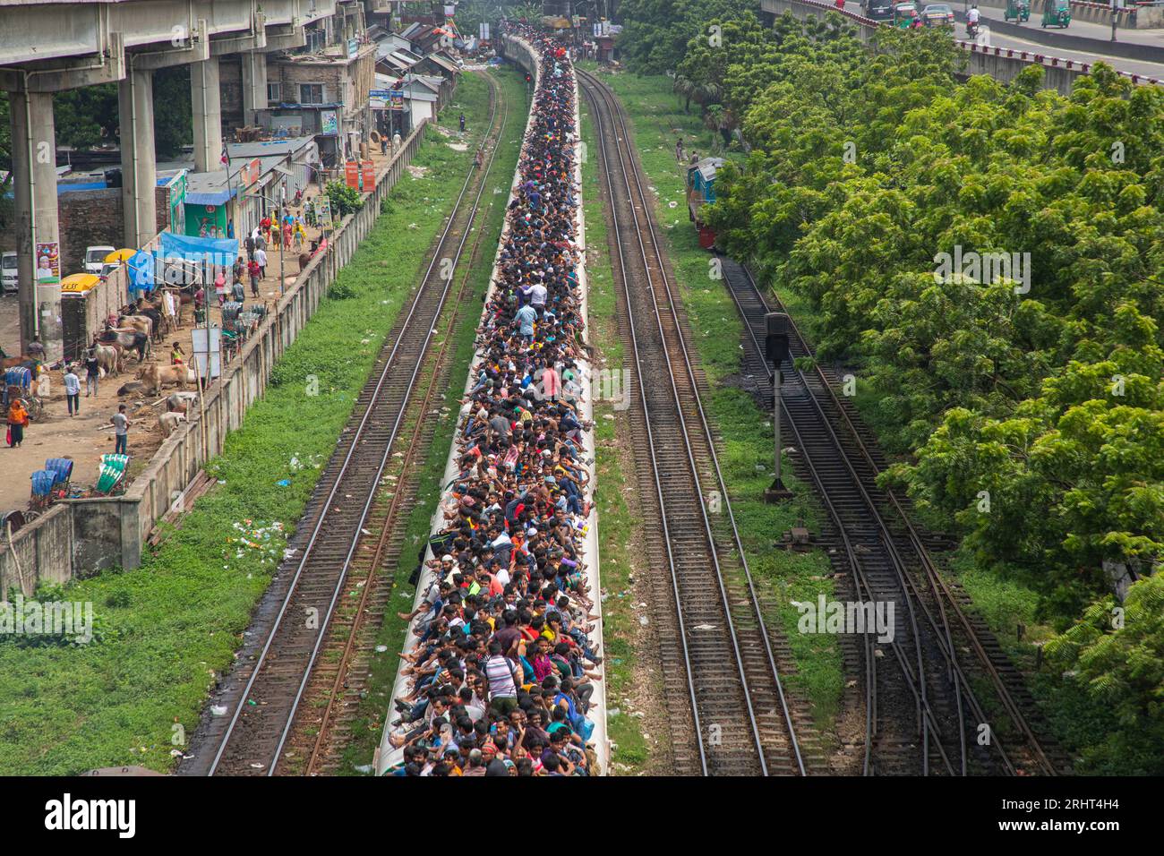 An overcrowded train leaves the Kamlapur Railway Station in Dhaka ahead ...