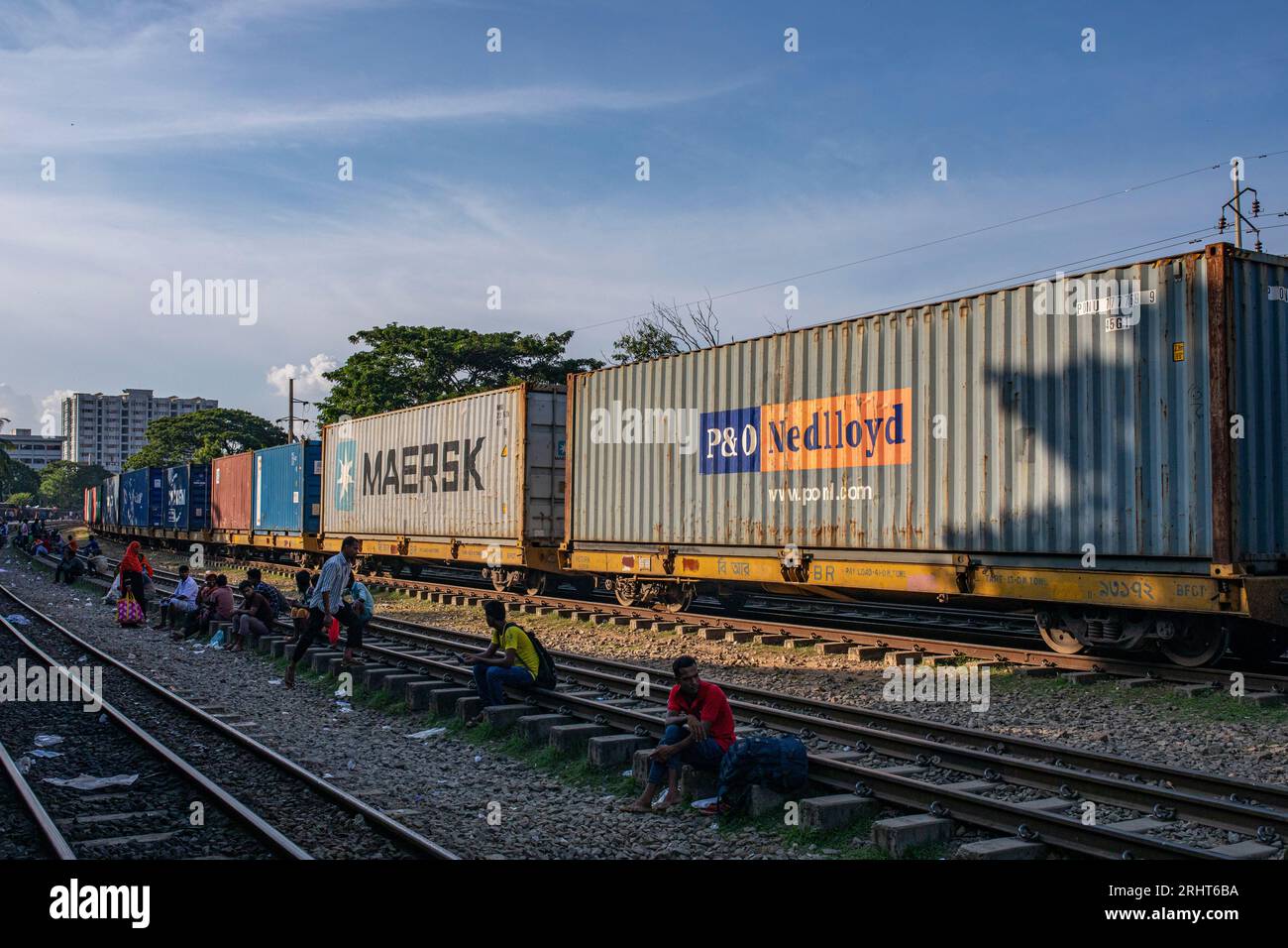 A shipping container trail cross the Airport Railway Station in Dhaka ...