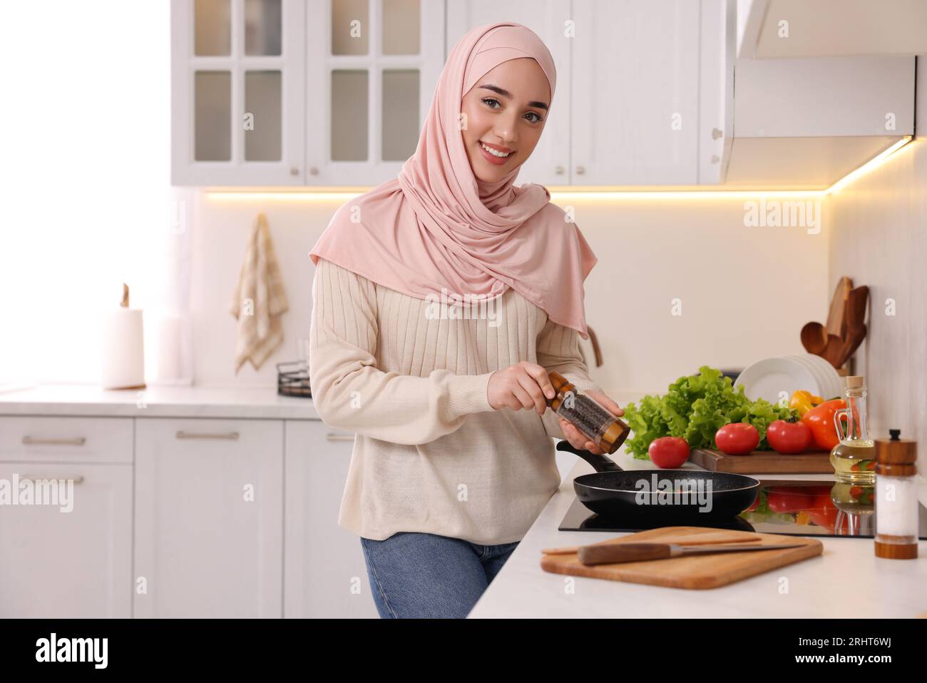 Arab woman cooking in kitchen hi-res stock photography and images - Alamy
