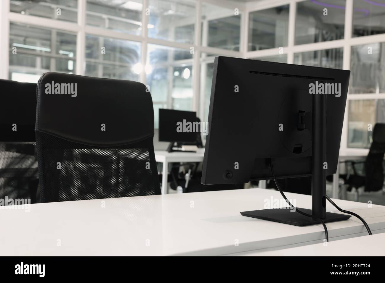 Workspace with tables and chairs indoors. Open plan office interior ...