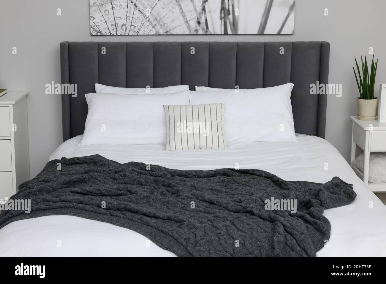 Large comfortable bed in room. Stylish interior Stock Photo - Alamy