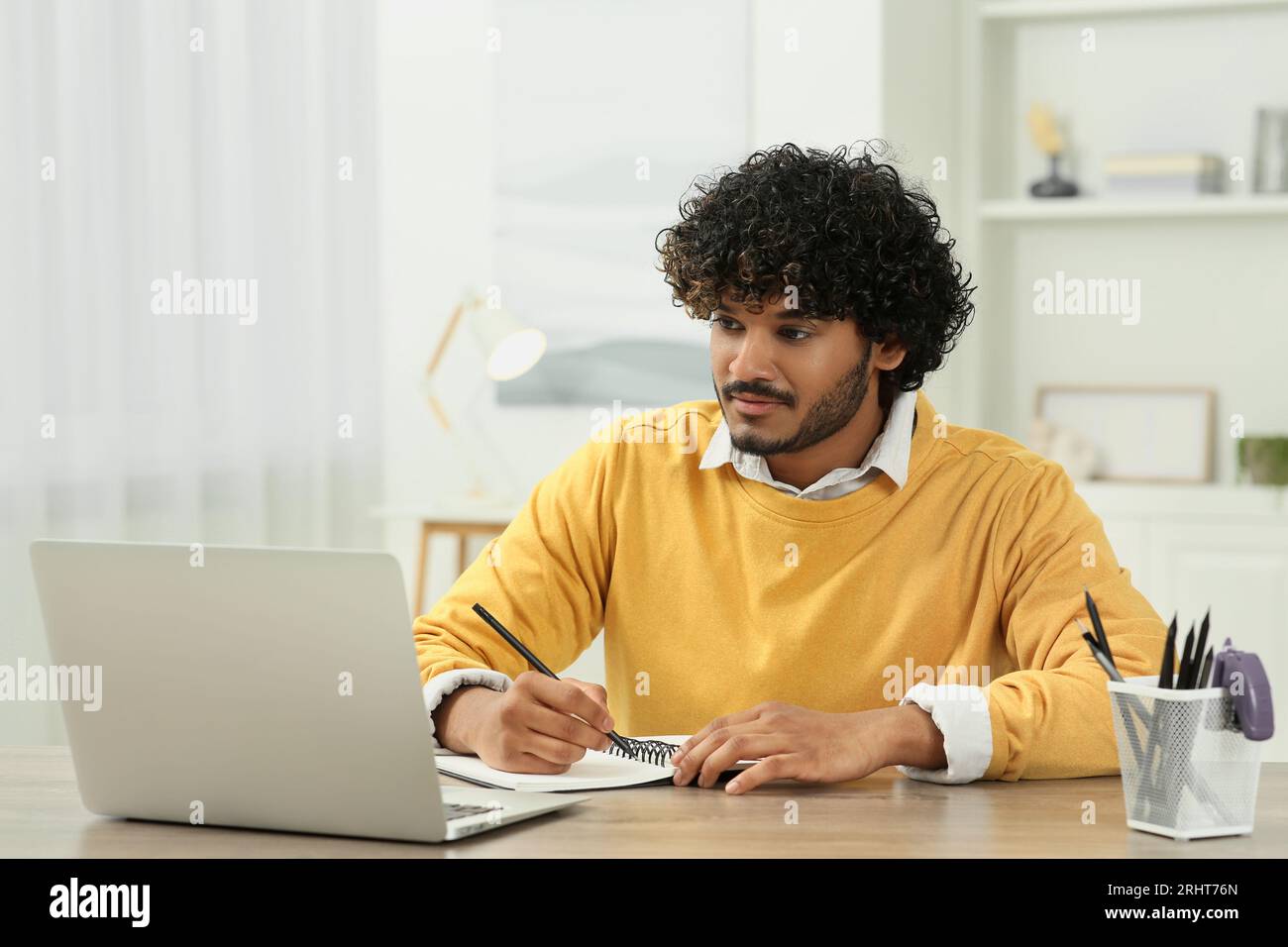 Taking notes at laptop hi-res stock photography and images - Alamy