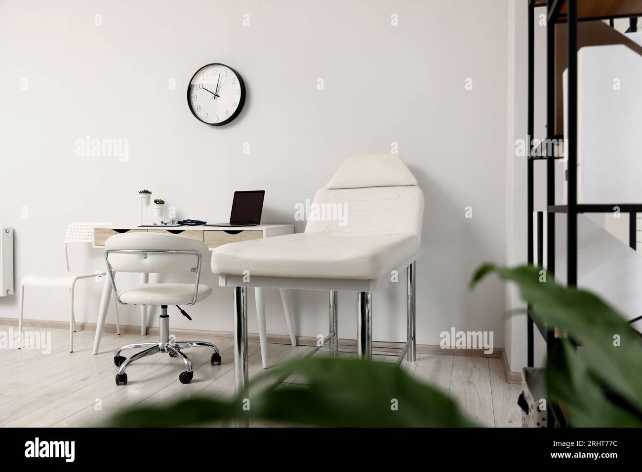 Modern medical office with doctor's workplace and examination table in ...