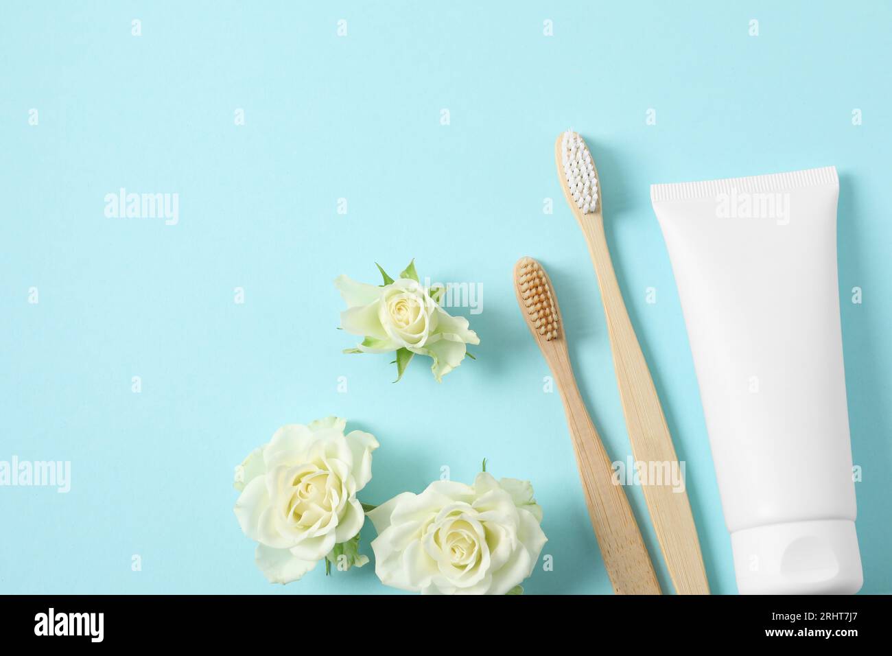 Flat lay composition with toothbrushes, toothpaste and flowers on ...