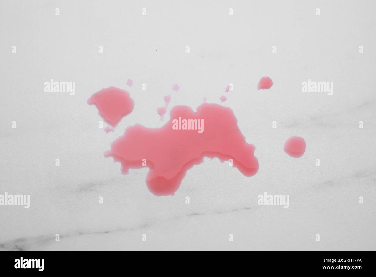 Puddle of red liquid on white marble surface, top view Stock Photo - Alamy