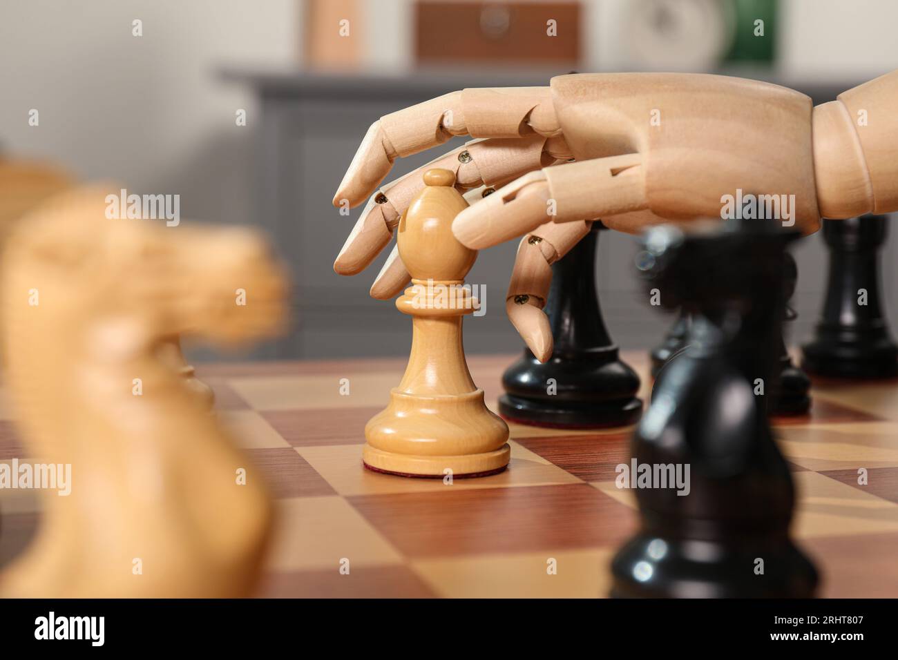 Robot moving chess piece on board, closeup. Wooden hand representing ...