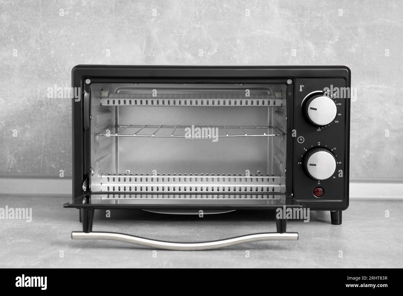 One electric oven on light grey table. Cooking appliance Stock Photo ...