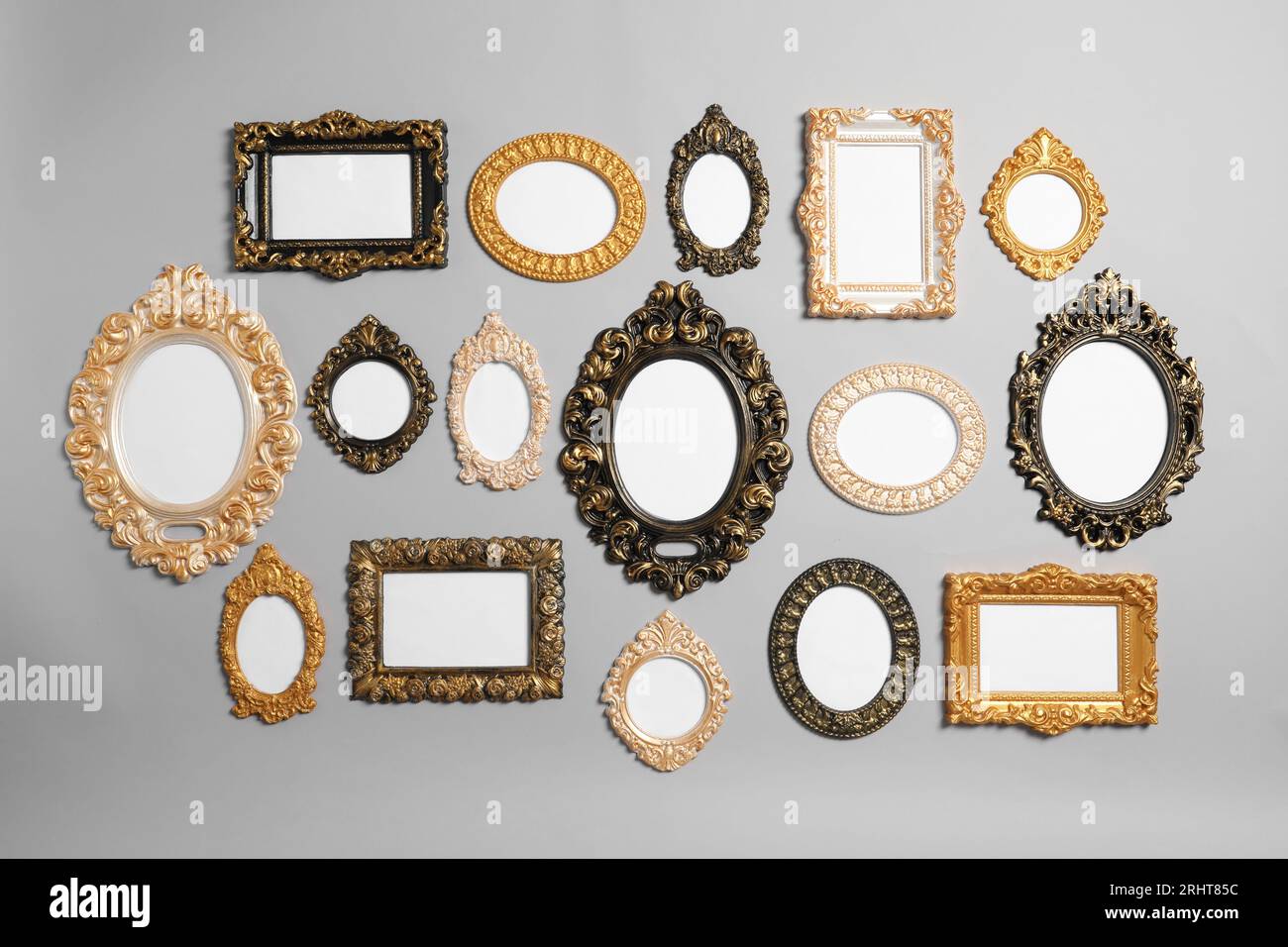 Empty vintage frames hanging on light gray wall Stock Photo - Alamy