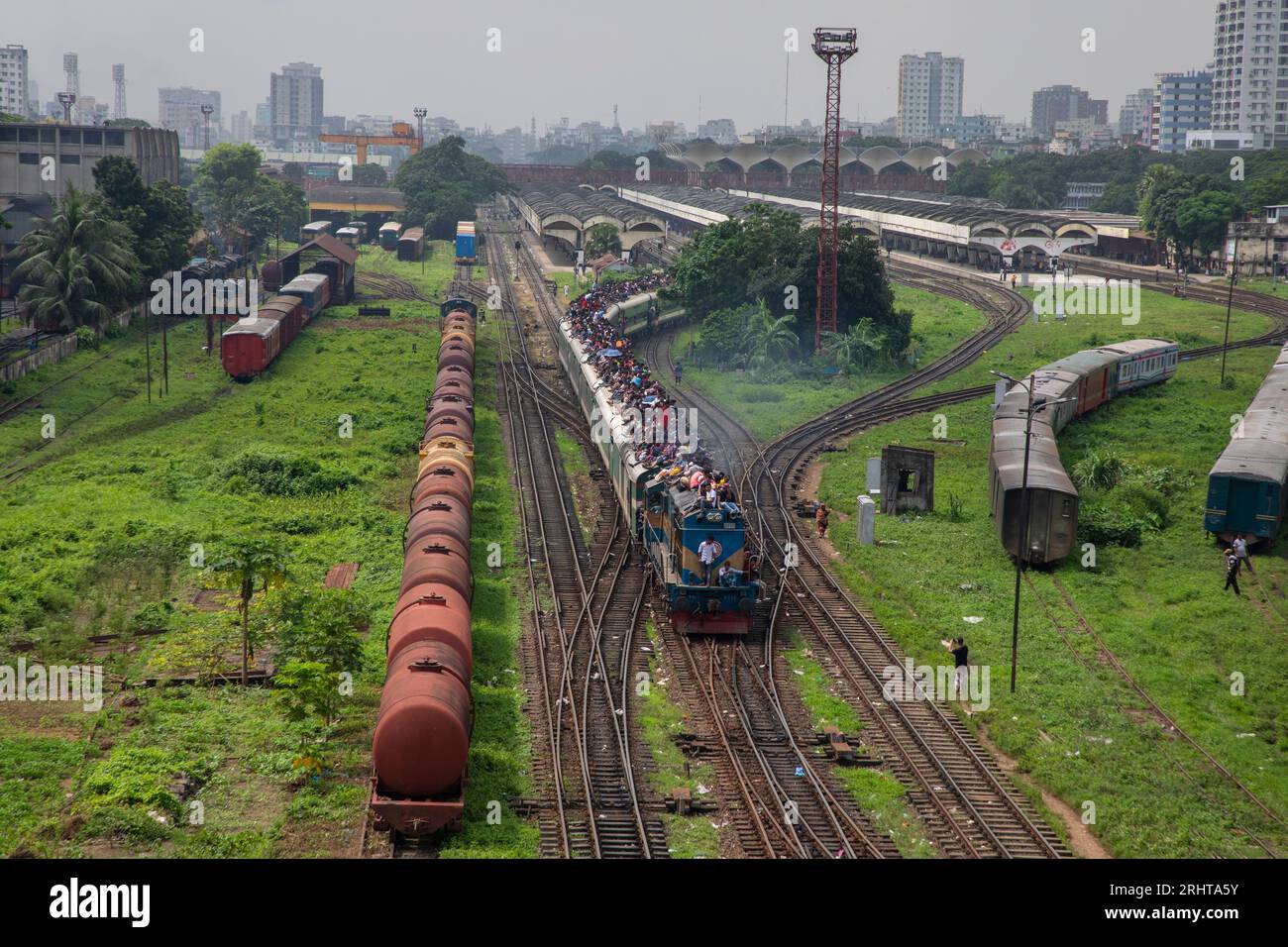 An overcrowded train leaves the Kamlapur Railway Station in Dhaka ahead ...
