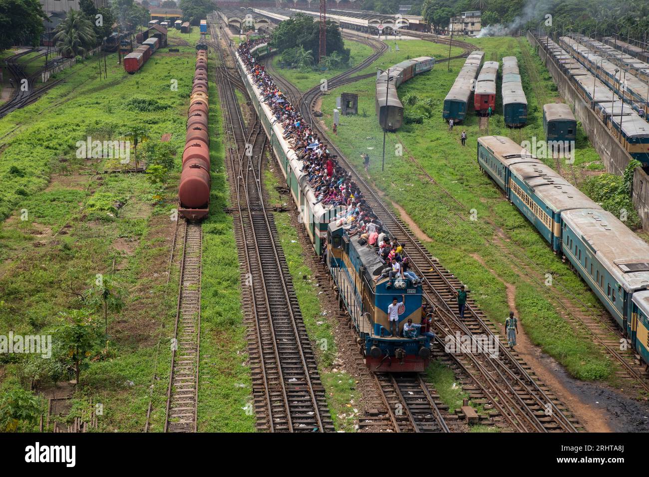 An overcrowded train leaves the Kamlapur Railway Station in Dhaka ahead ...