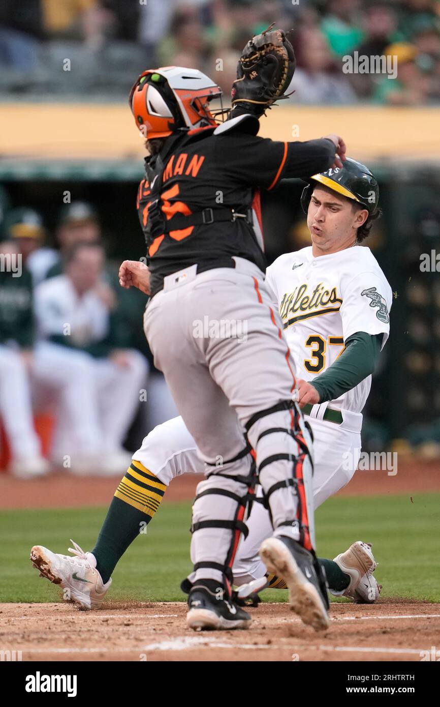 Oakland Athletics' Tyler Soderstrom, right, slides home to score ...