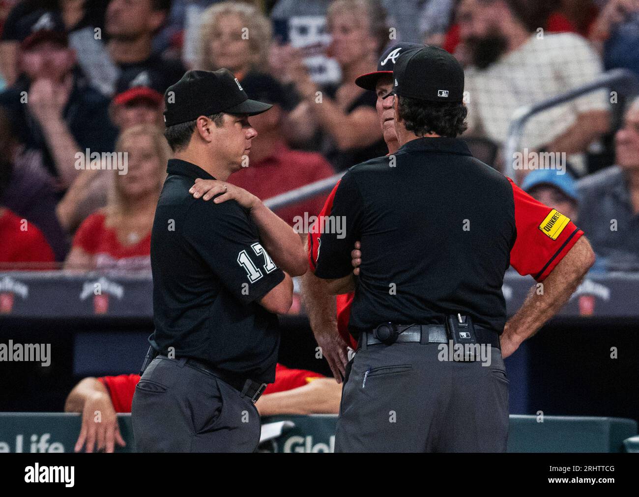 Umpires DJ Reyburn (17) and James Hoyein speak to Atlanta Braves ...