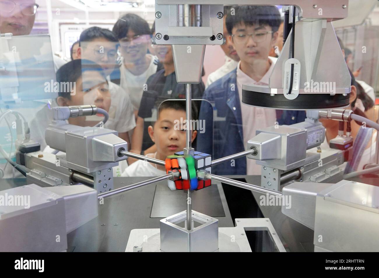 Children watch a robot playing a Rubic's cube at the World Robot ...