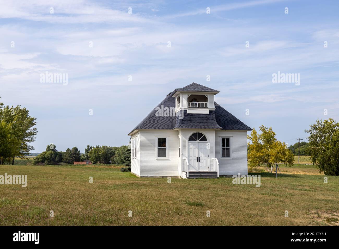 Sunny landscape view of a rural 19th century wood constructed one-room ...