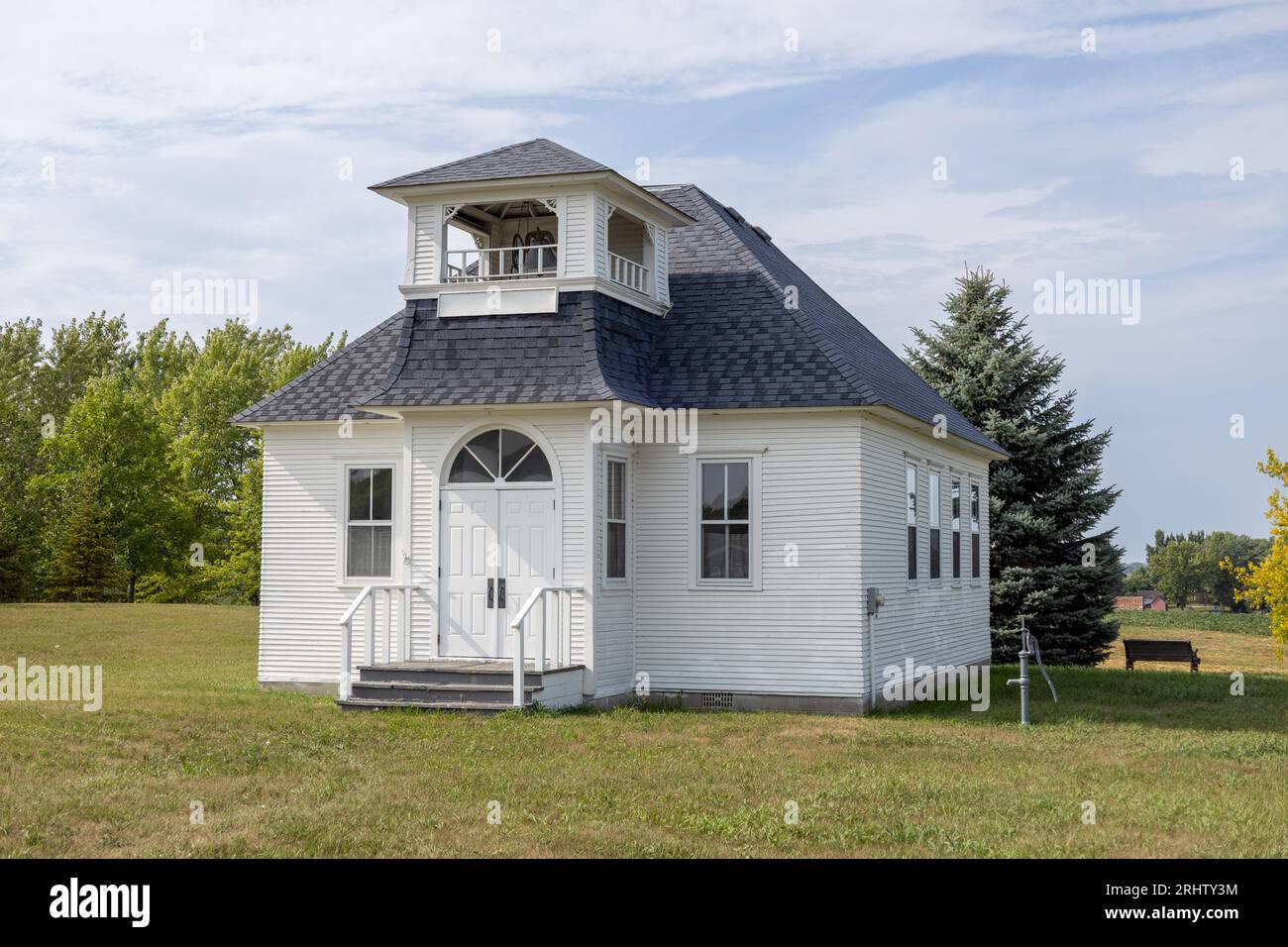 Sunny landscape view of a rural 19th century wood constructed one-room ...