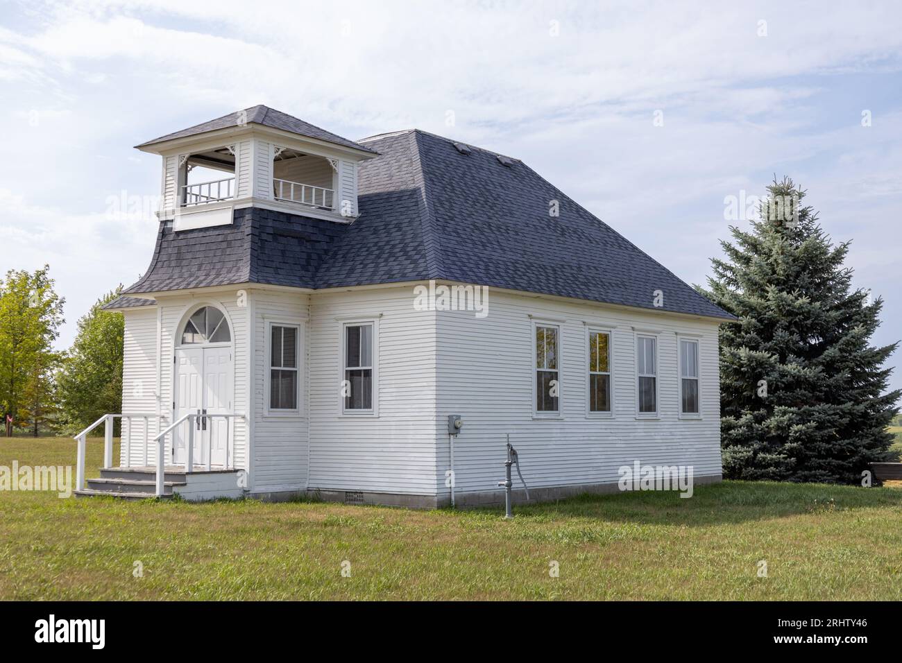 Sunny landscape view of a rural 19th century wood constructed one-room ...