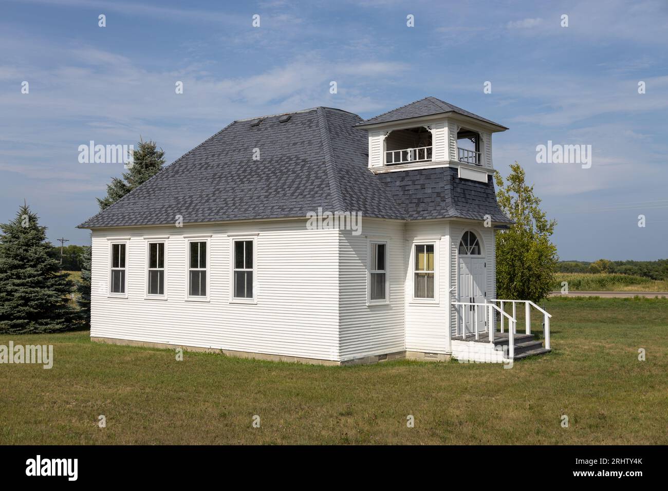 Sunny landscape view of a rural 19th century wood constructed one-room ...